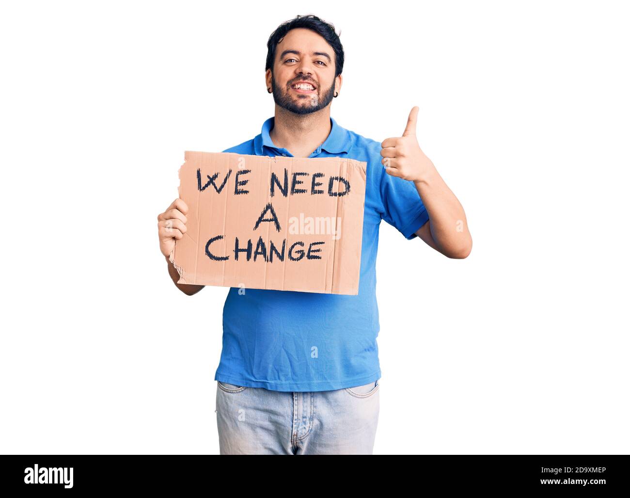 Young hispanic man holding we need a change banner smiling happy and ...