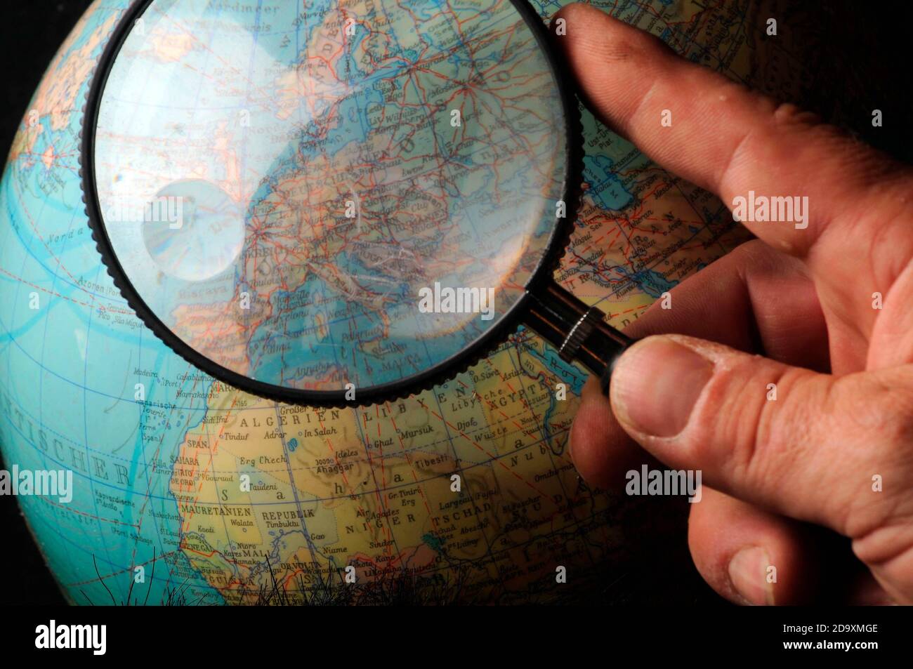 watching europe with a magnifying glass on a globe, european union ...