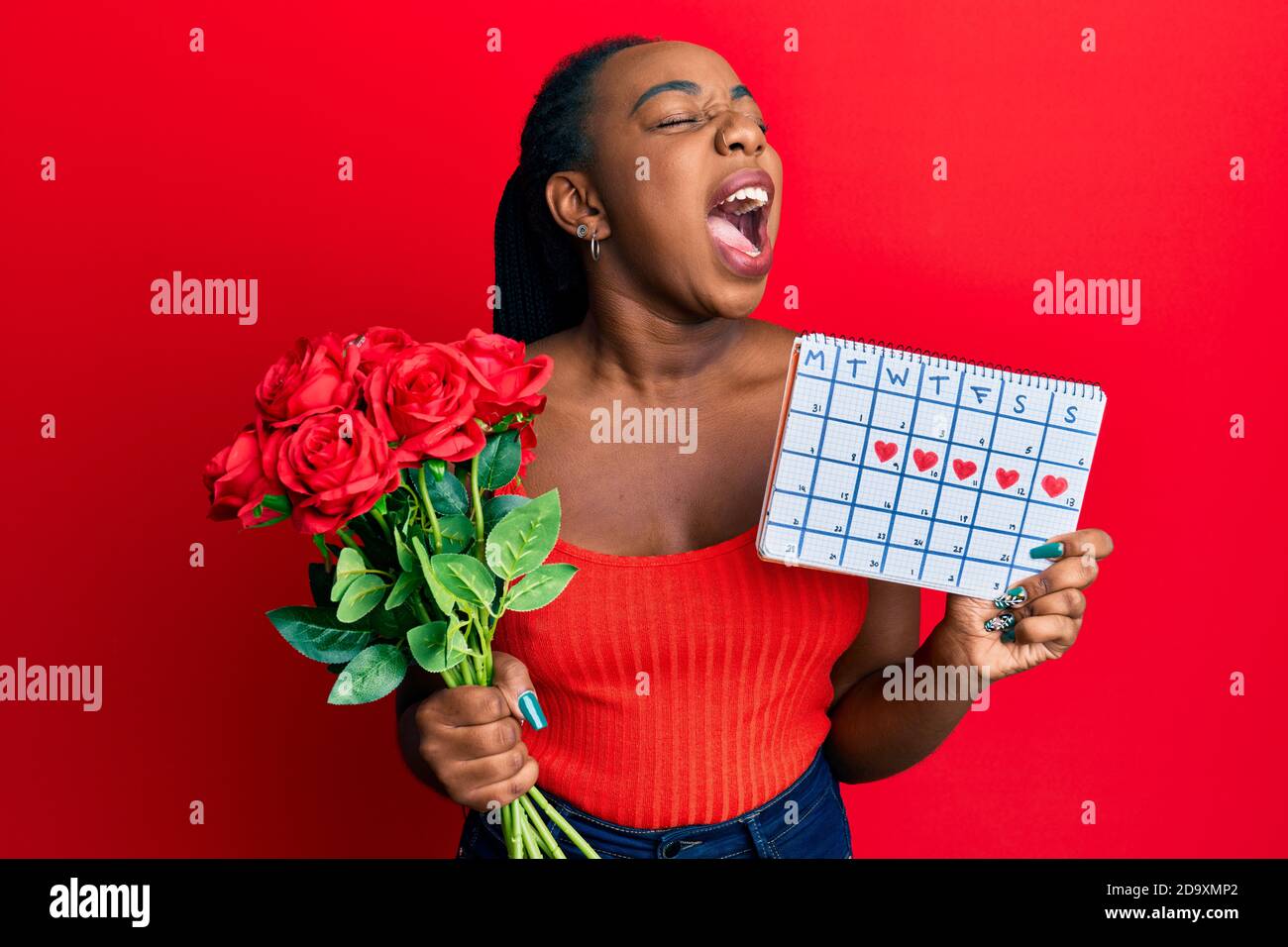 Young african american woman holding heart calendar and flowers angry ...