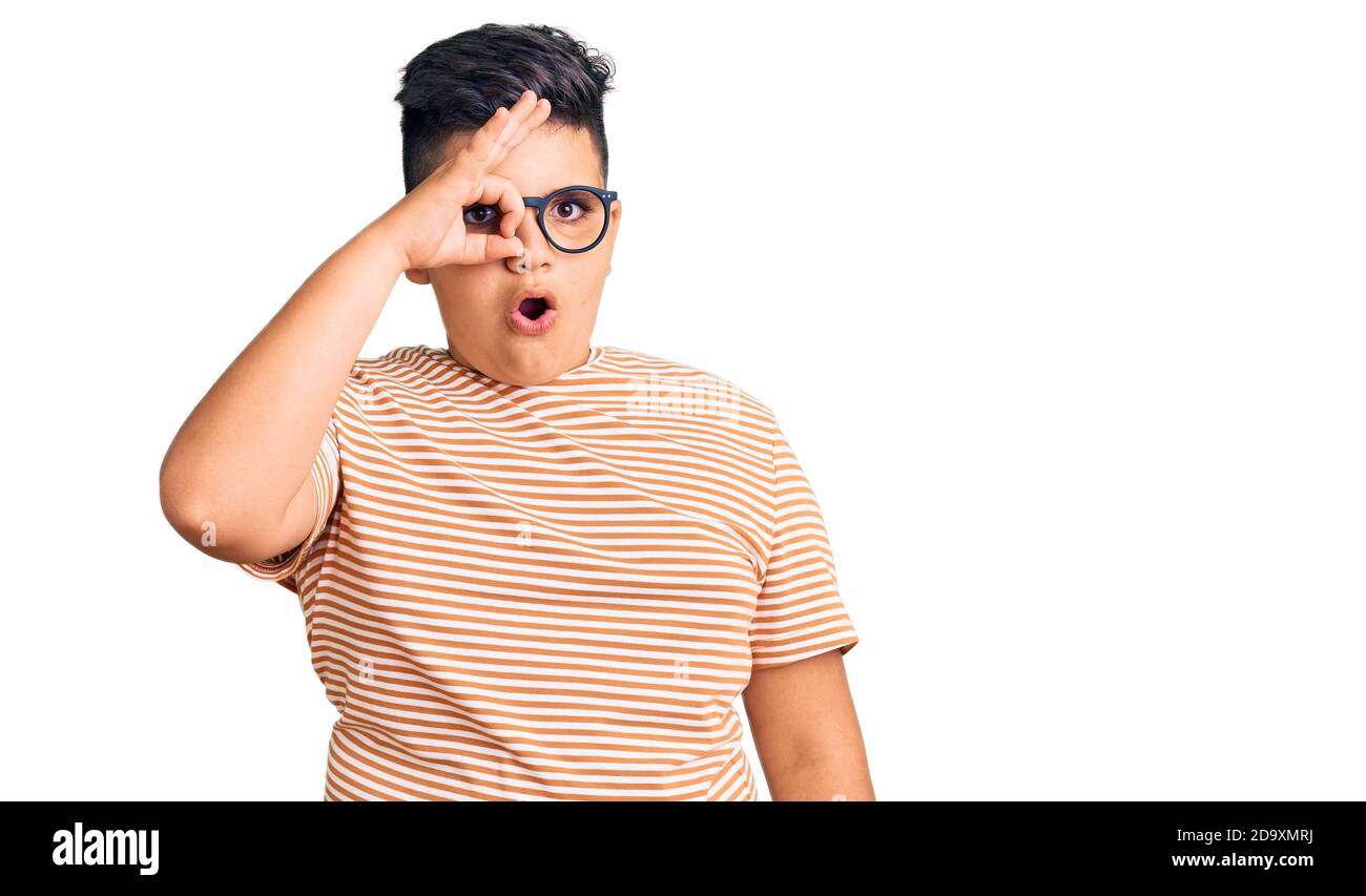 Little boy kid wearing casual clothes and glasses doing ok gesture ...