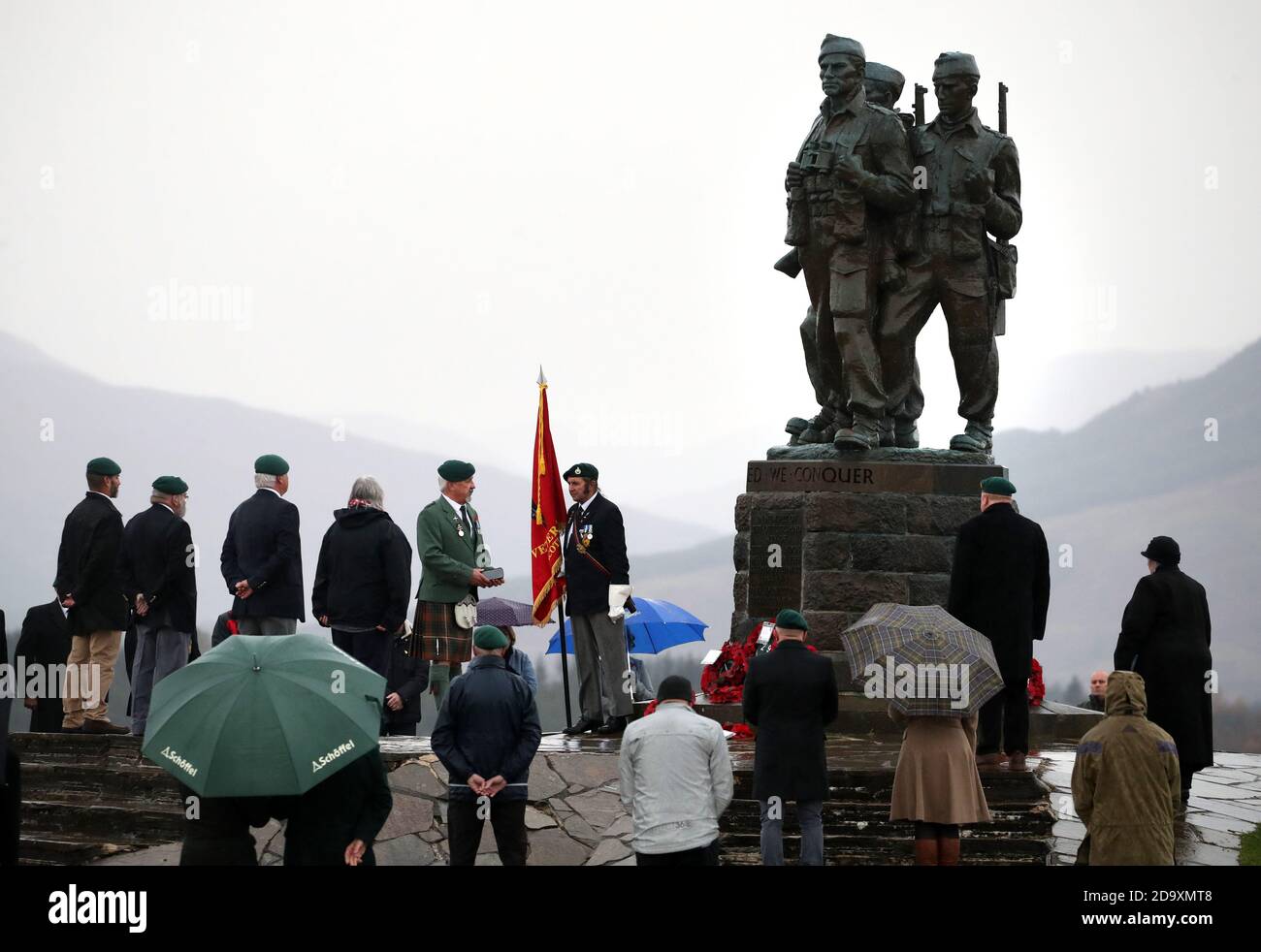 A small number of serving and former Royal Marine Commandos at the Commando Memorial at Spean ...