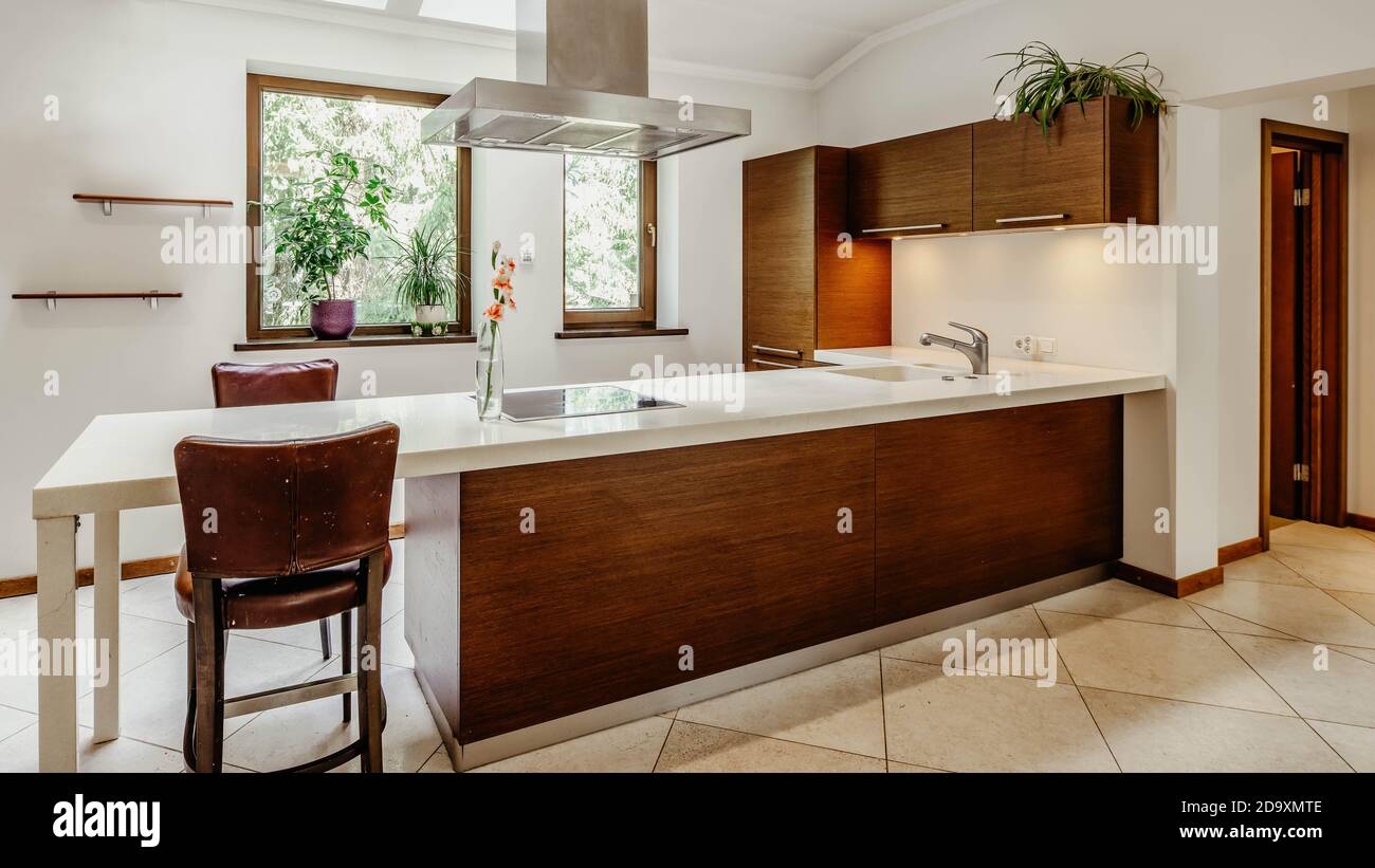Modern spacious interior of kitchen. Wooden kitchen set with white ...