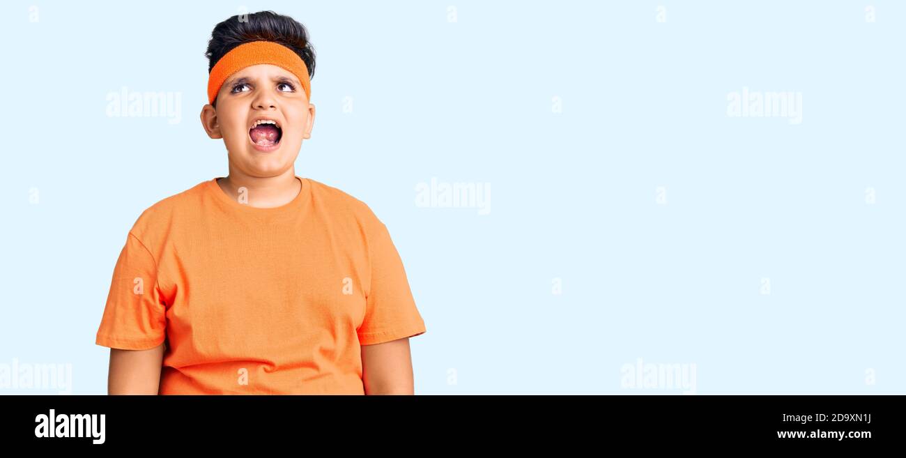 Little boy kid wearing sportswear angry and mad screaming frustrated ...