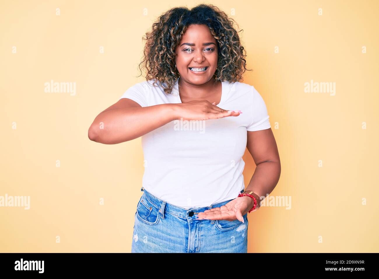 Young african american plus size woman wearing casual white tshirt ...