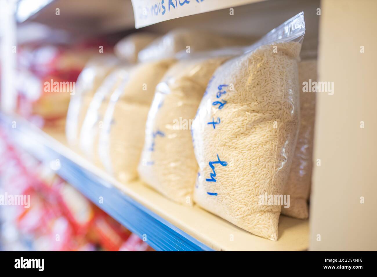 Rice Packed in Plastic Bags and on a Shelf Ready for Sale Stock Photo ...