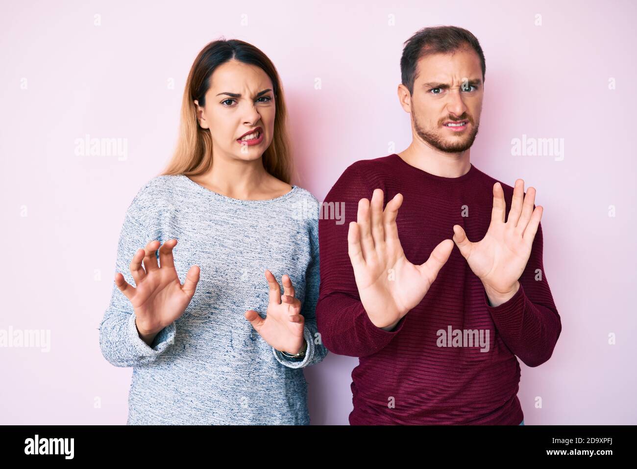 Beautiful couple wearing casual clothes disgusted expression ...