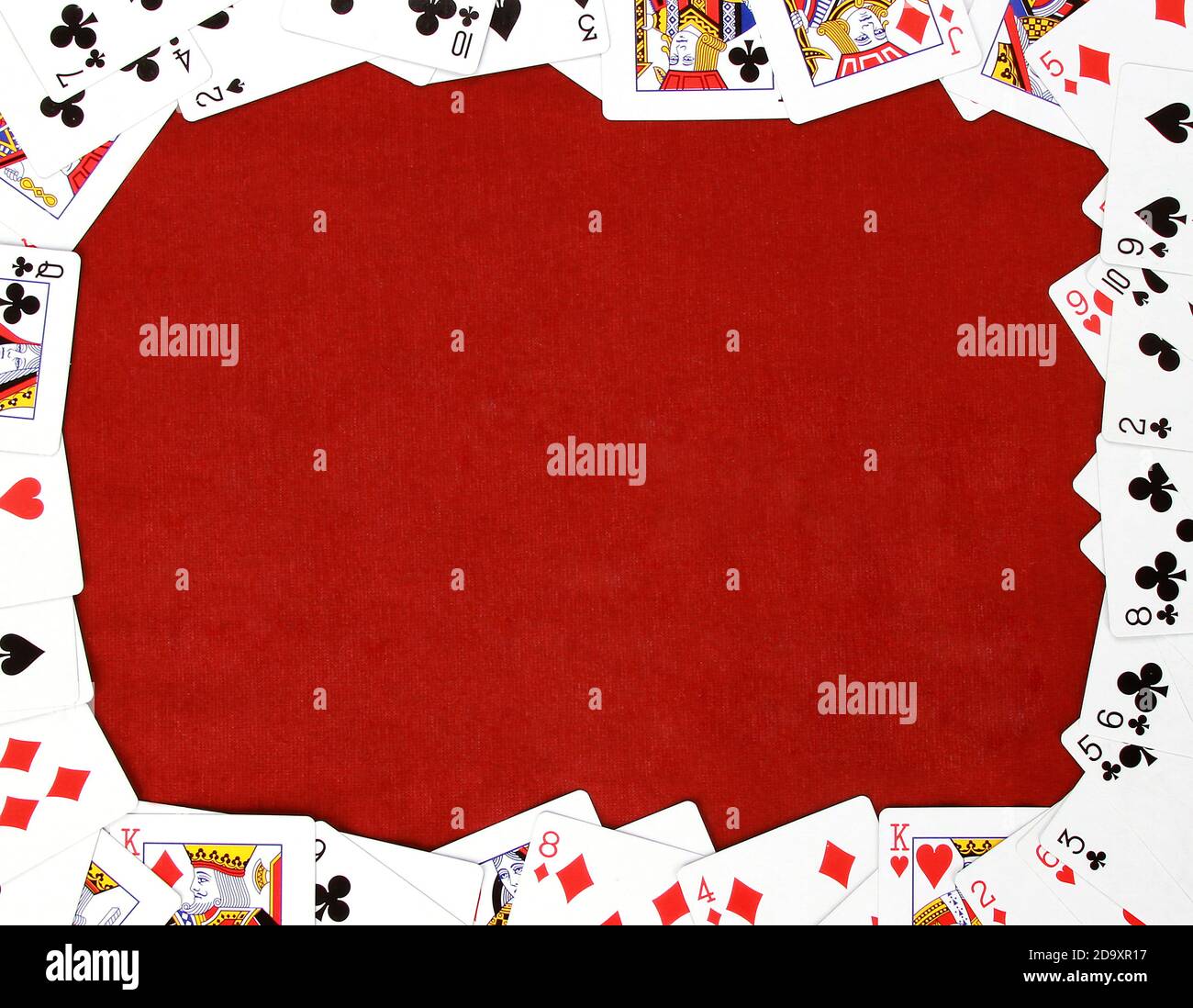 Top view closeup of playing cards spread all over the red table Stock ...