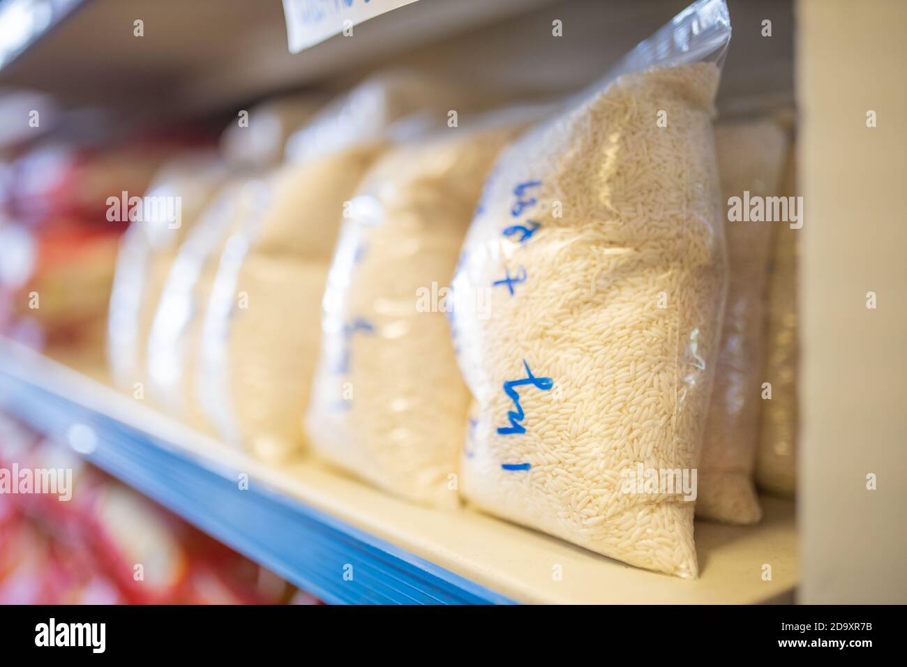 Rice Packed in Plastic Bags and on a Shelf Ready for Sale Stock Photo ...