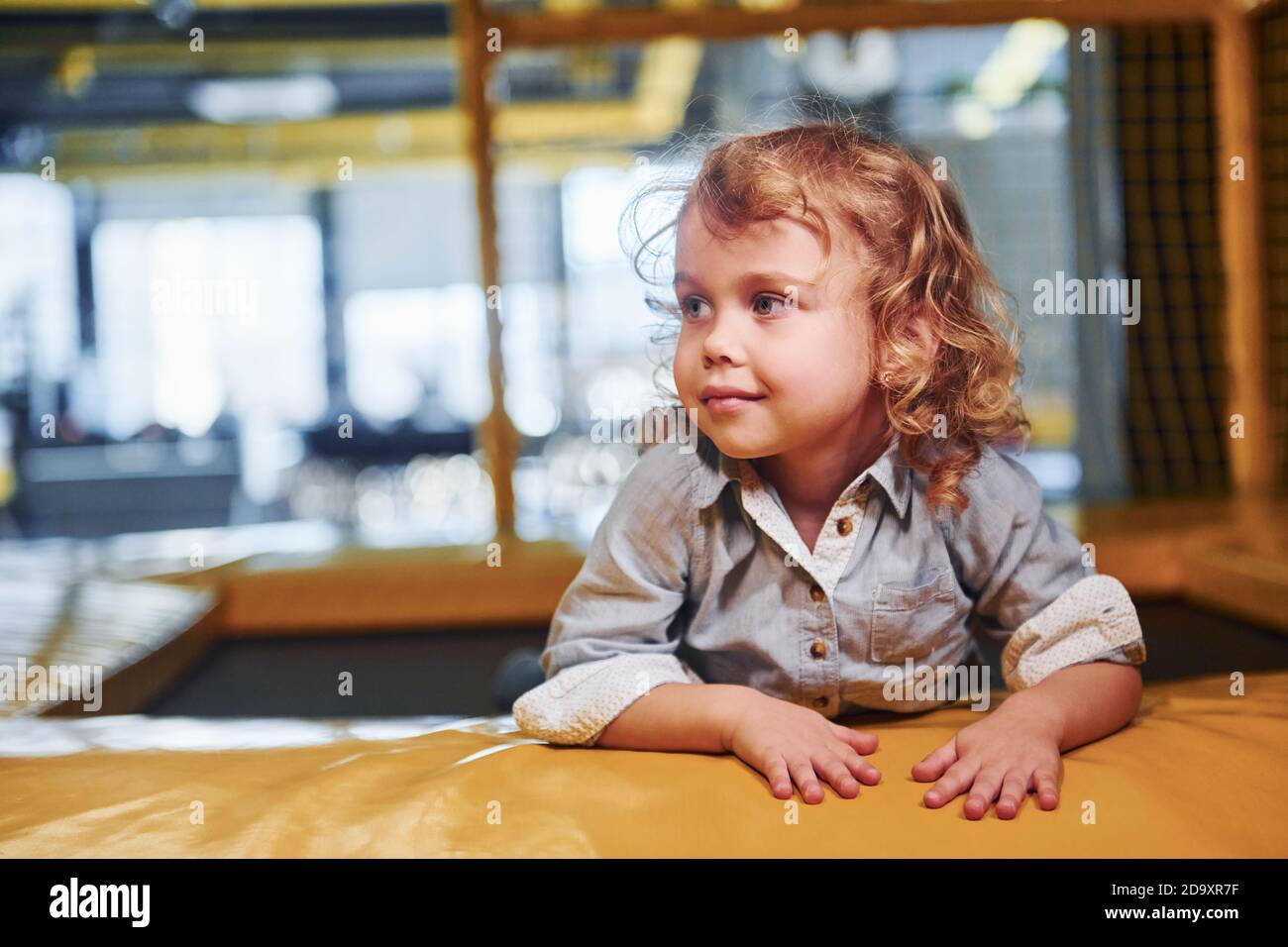 Child sitting in playroom. Kindergarten educational games Stock Photo ...