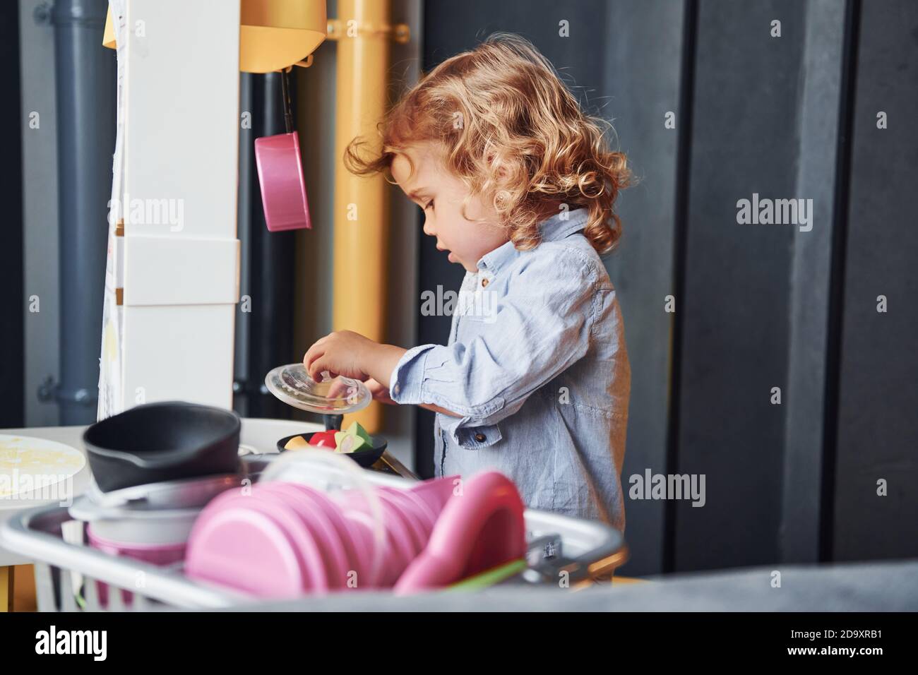 Child in casual clothes have fun by learning how to prepare food Stock ...