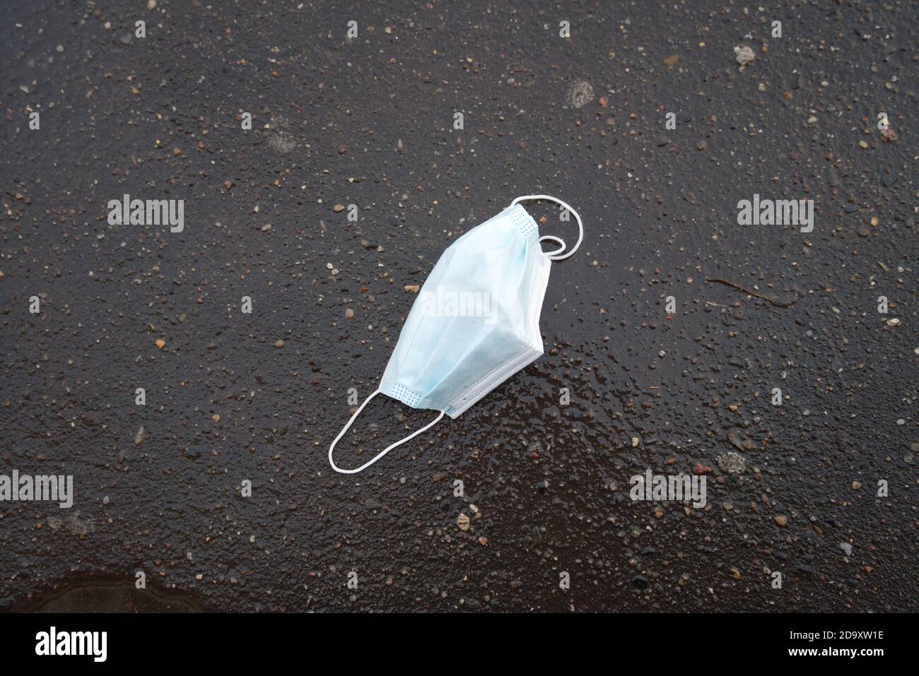 dirty used white medical mask laying as trash on asphalt street Stock ...