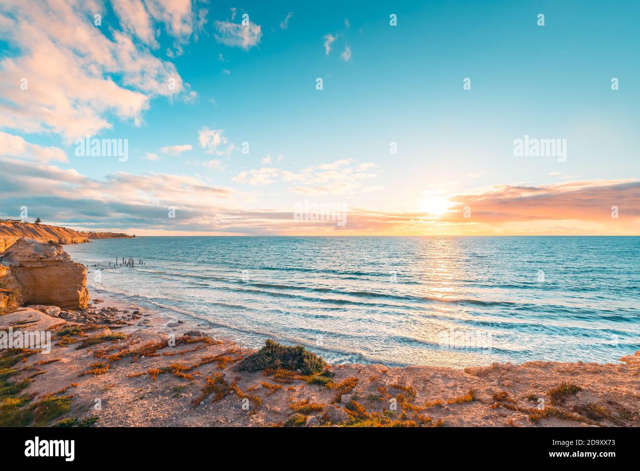 Port Willunga beach with jetty pylons at sunset, South Australia Stock ...