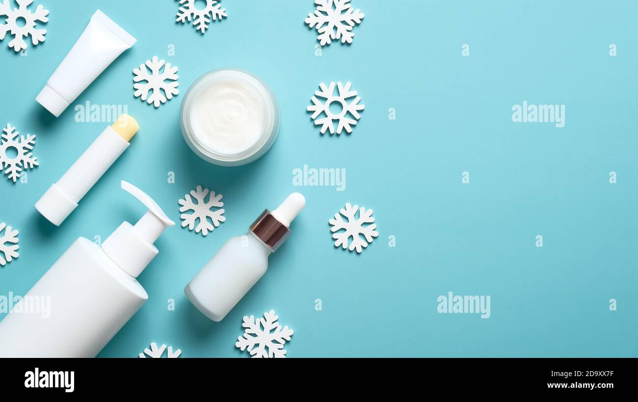 Winter skin care concept. Set of cosmetic products and snowflakes on ...