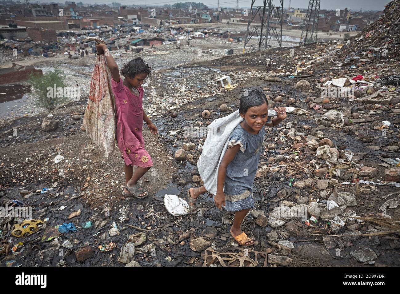 Delhi, India, July 2009. Children at work picking up rubbish at a dump ...