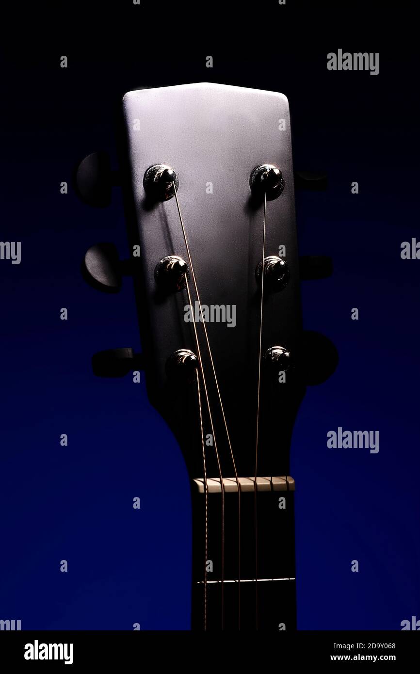 The fretboard of an acoustic guitar closeup. Studio photo of a musical ...