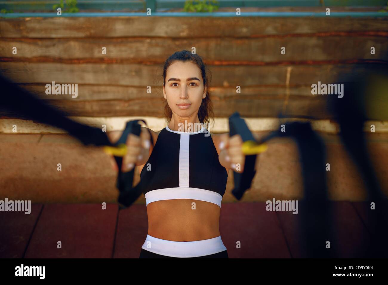Woman doing exercise with ropes, top view Stock Photo - Alamy
