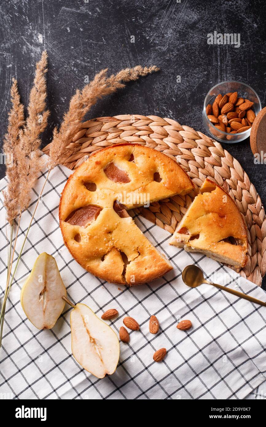 homemade crunchy pear pie on a black background and white tablecloth ...