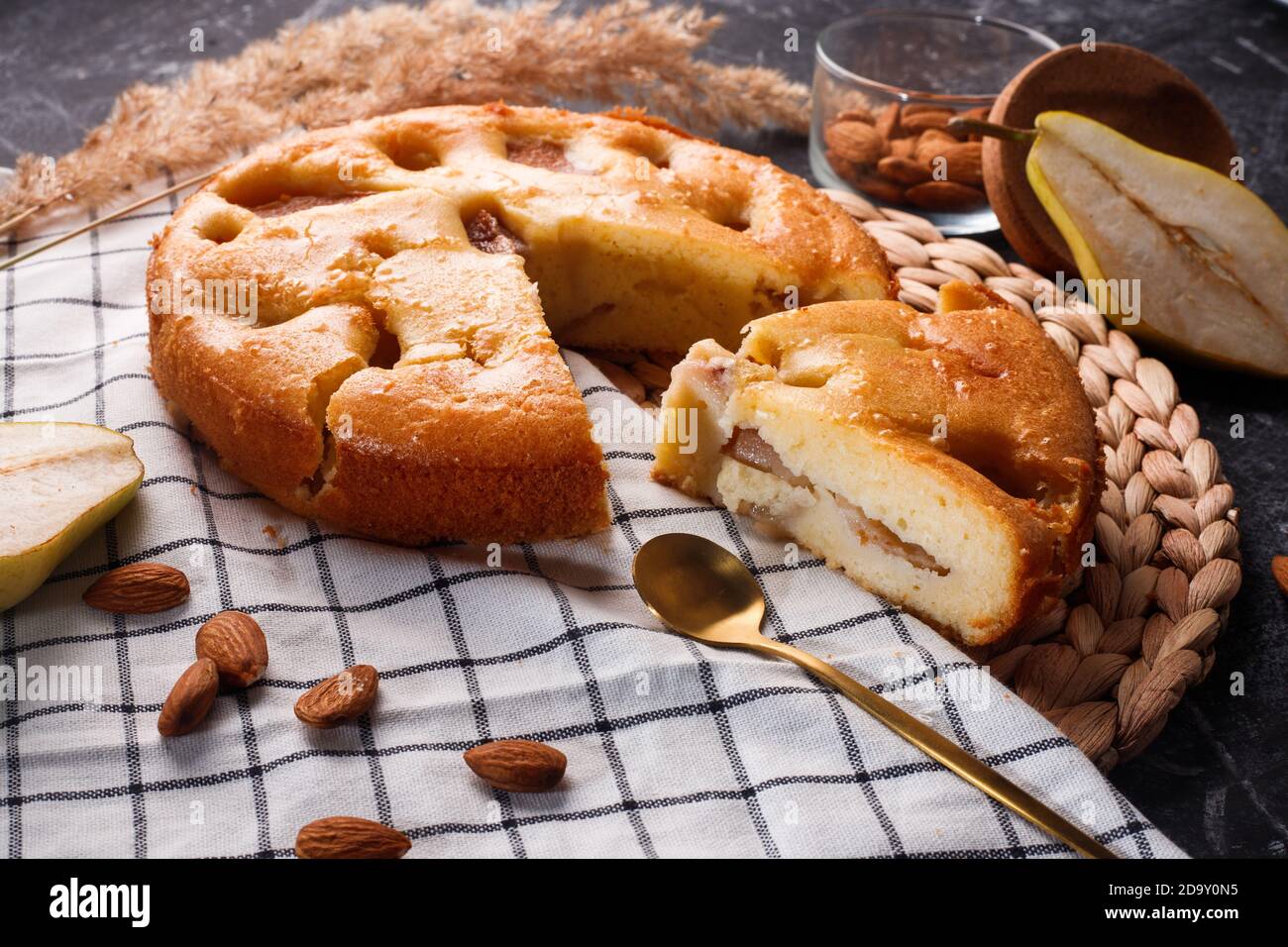 homemade crunchy pear pie on a black background and white tablecloth ...