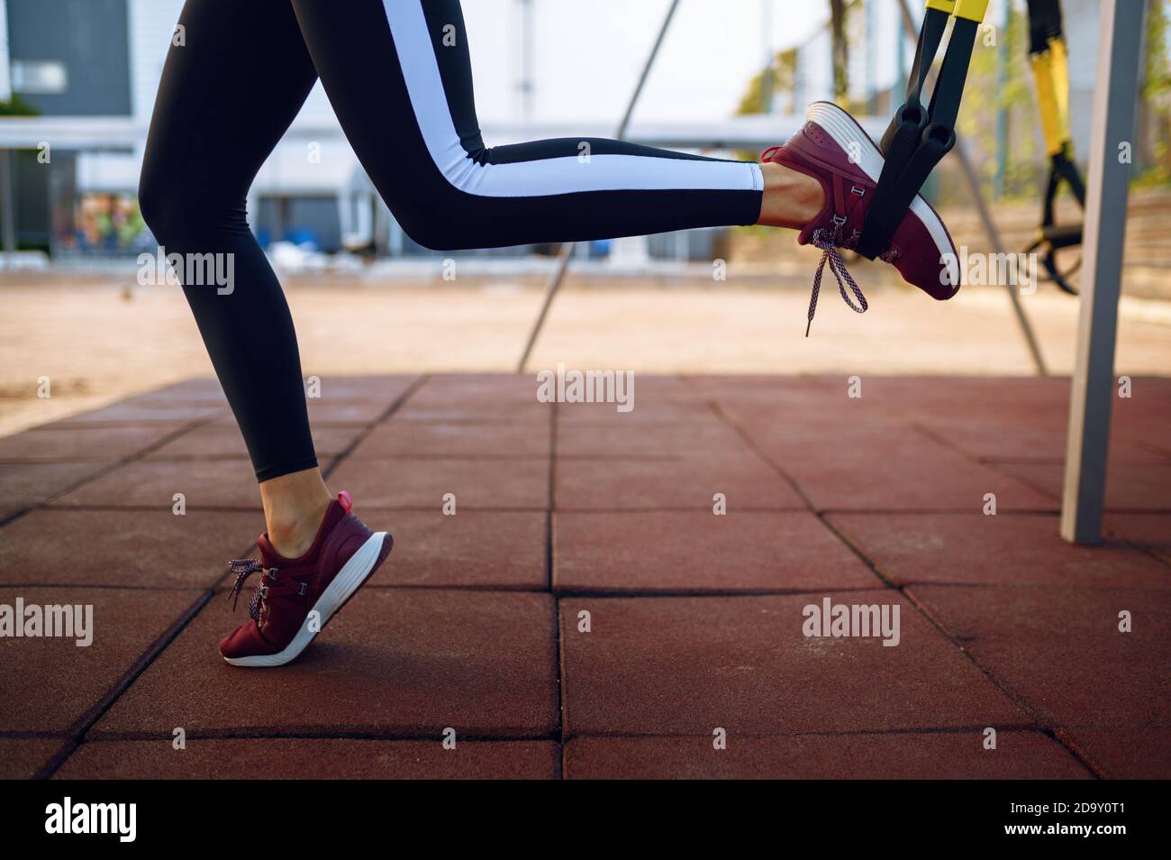 Woman doing stretching exercise with ropes outdoor Stock Photo - Alamy