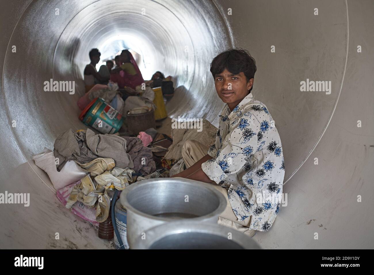 Delhi, India, July 2009. A family living in a drain pipe in a city slum ...