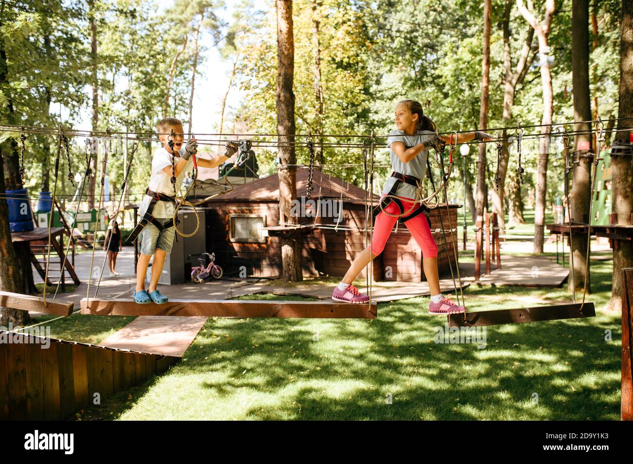 Little girl climbs in rope park Stock Photo - Alamy