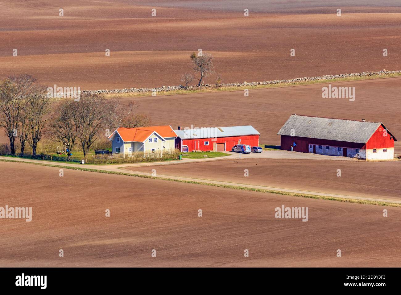 Rural view with a farm in the fields Stock Photo - Alamy