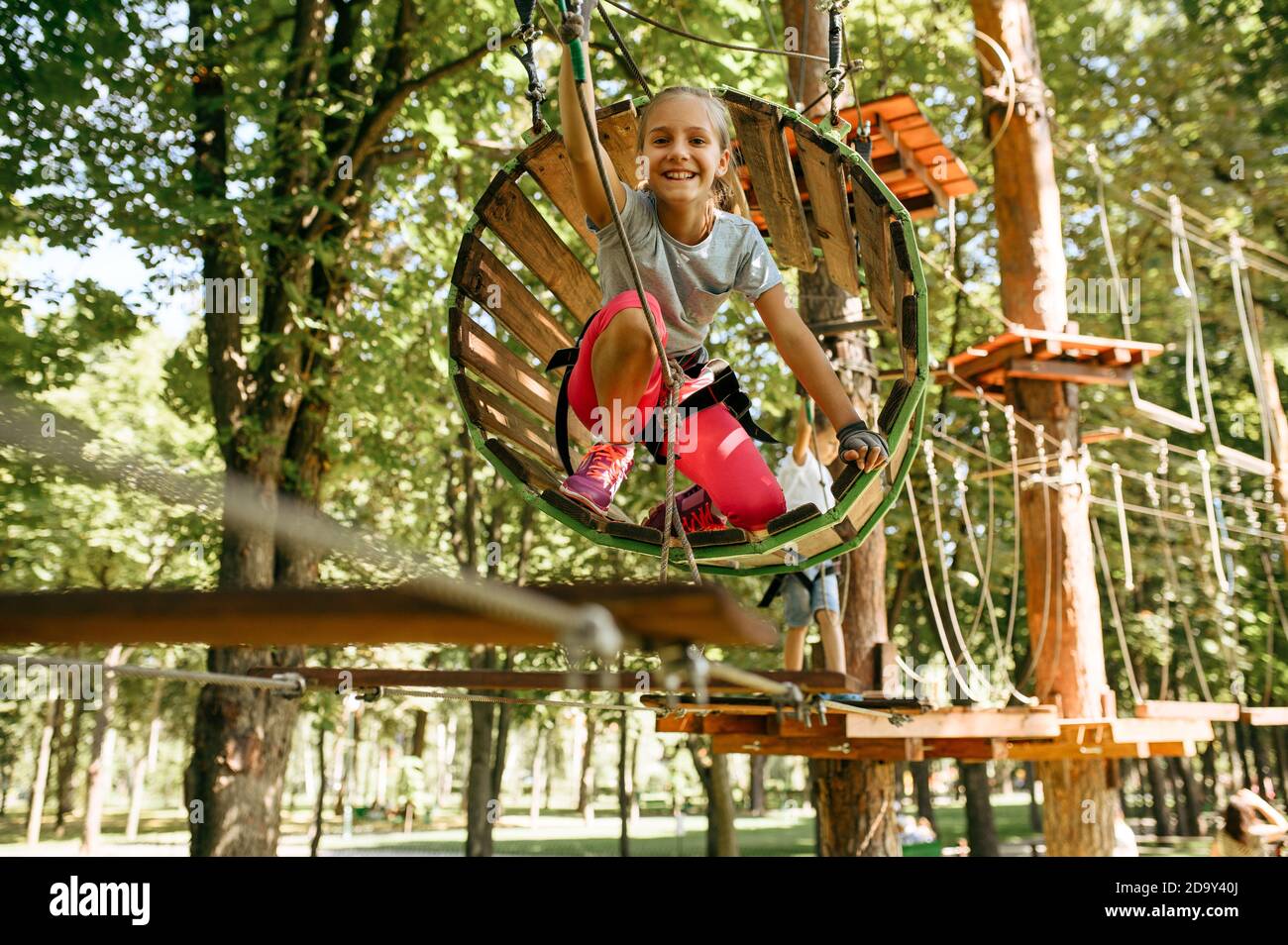 Teens in equipment climbs in rope park, playground Stock Photo - Alamy