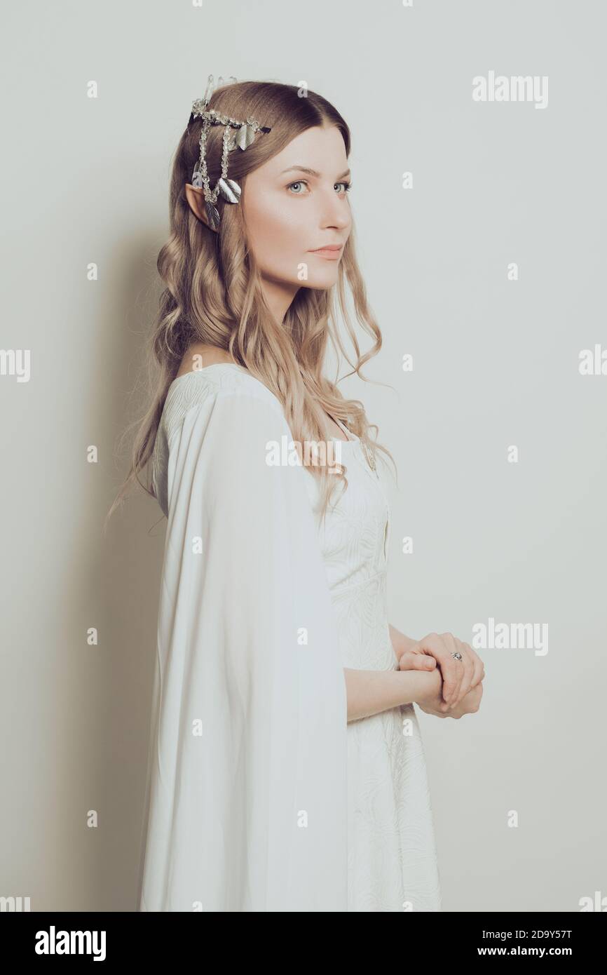 Calm woman elf in white dress. Mysterious elven sorceress princess ...