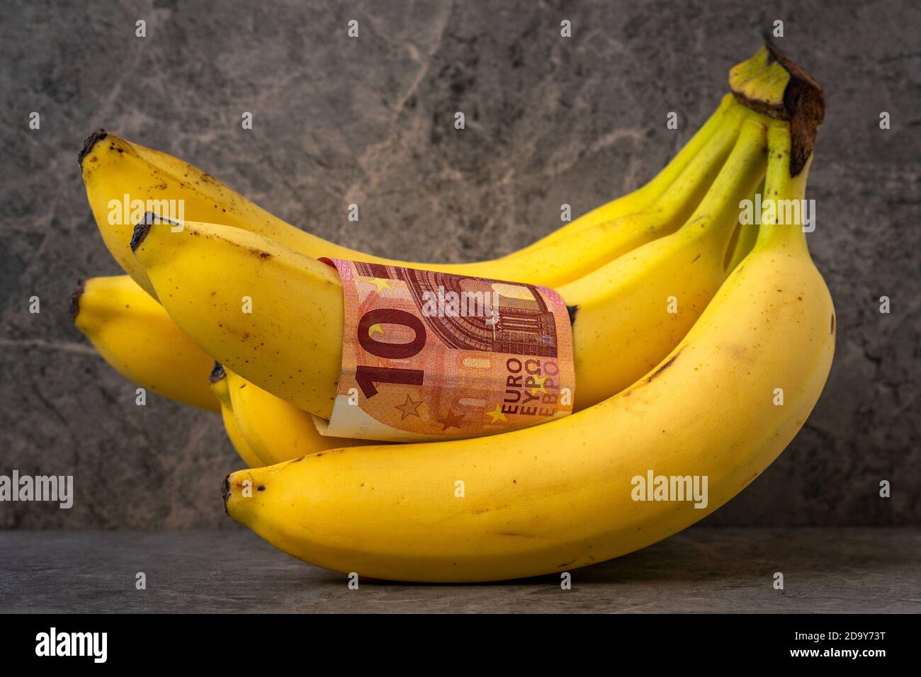 Bunch of ripe banana with ten euro banknote. Conceptual image Stock ...