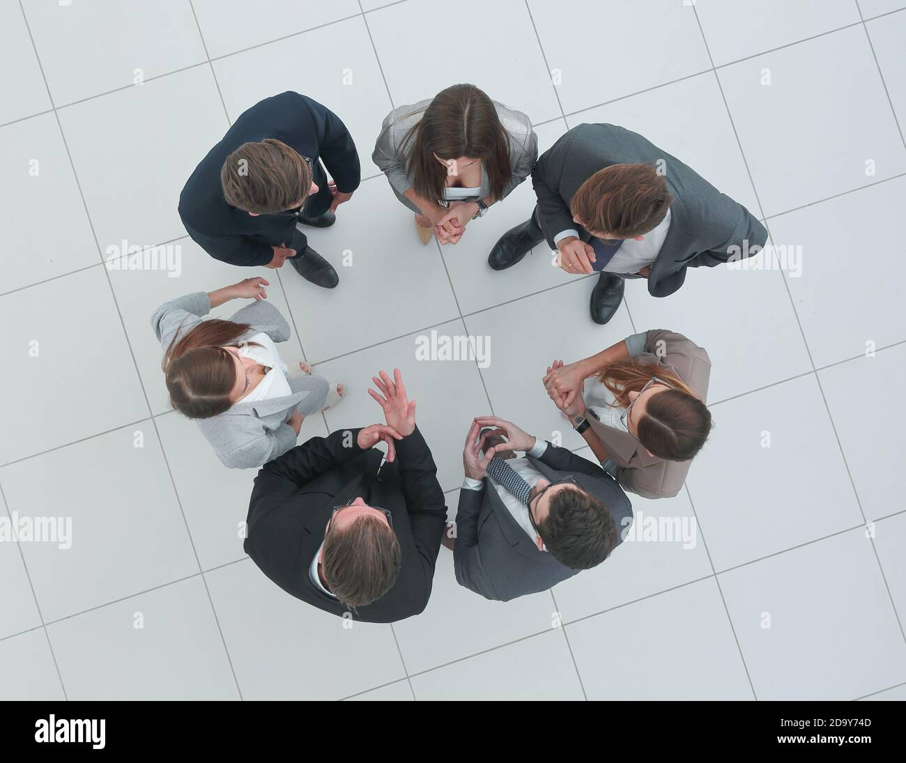 group of employees discussing something standing in a circle Stock ...