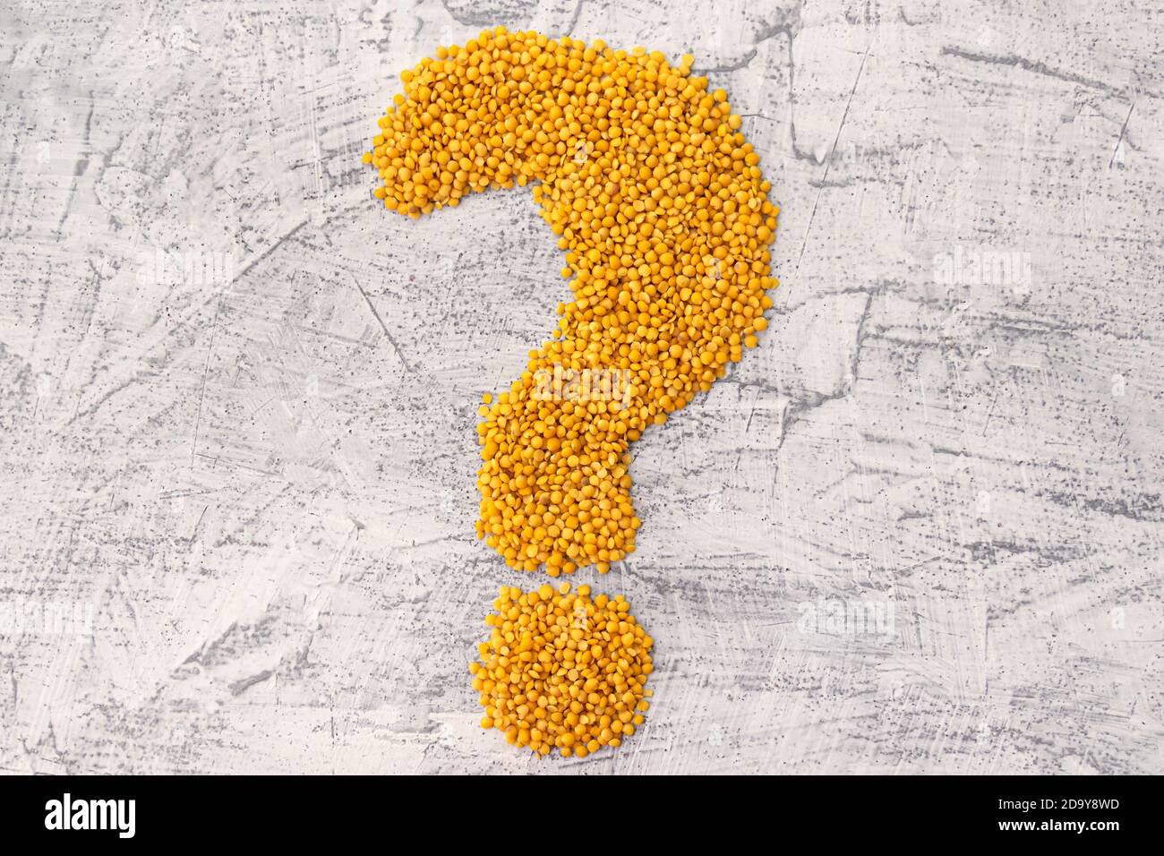 Yellow lentils on white stone background. Lentil background with ...