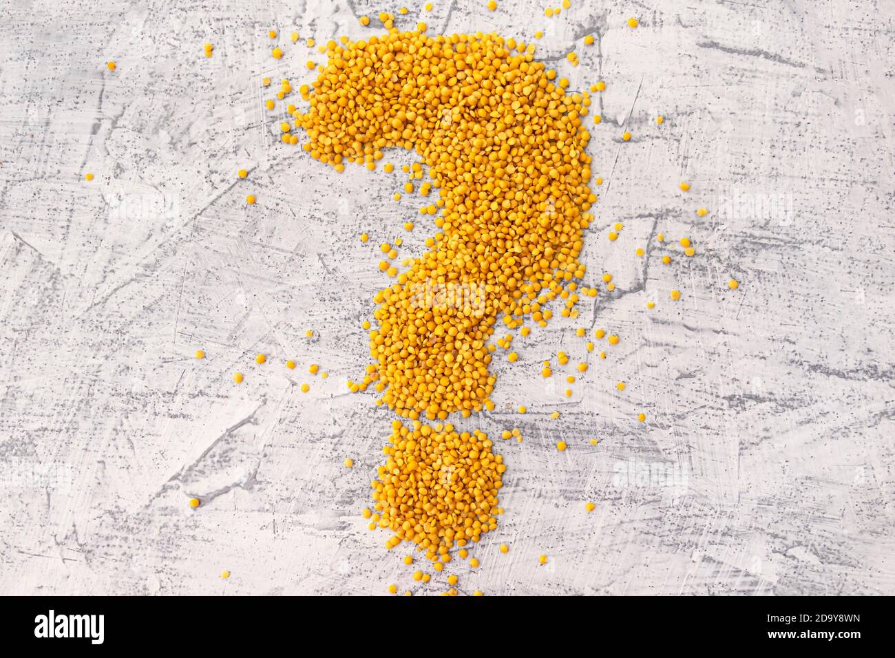 Yellow lentils on white stone background. Lentil background with ...