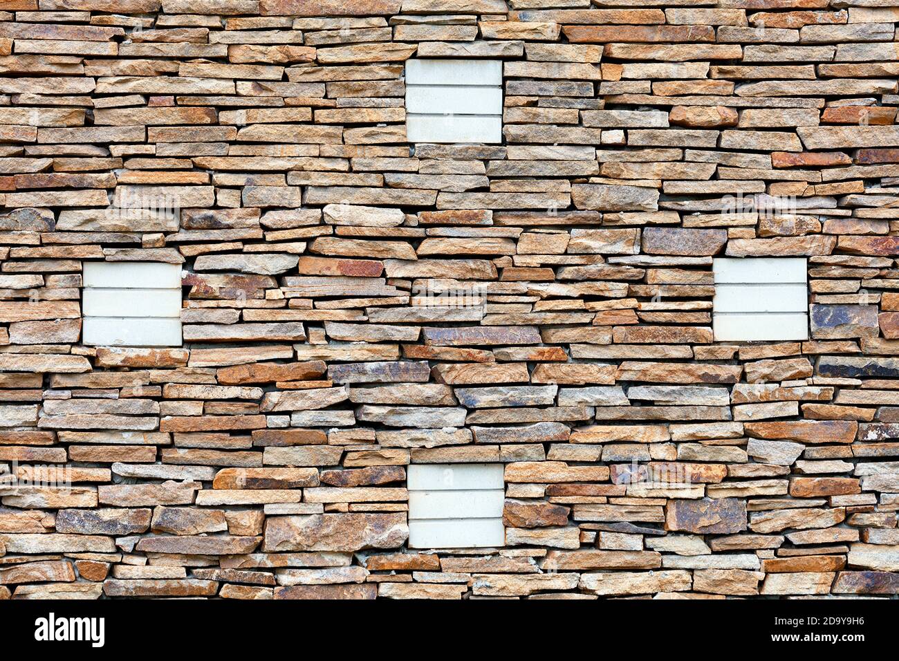 Part of a sandstone stone wall with silicate brick ornaments ...