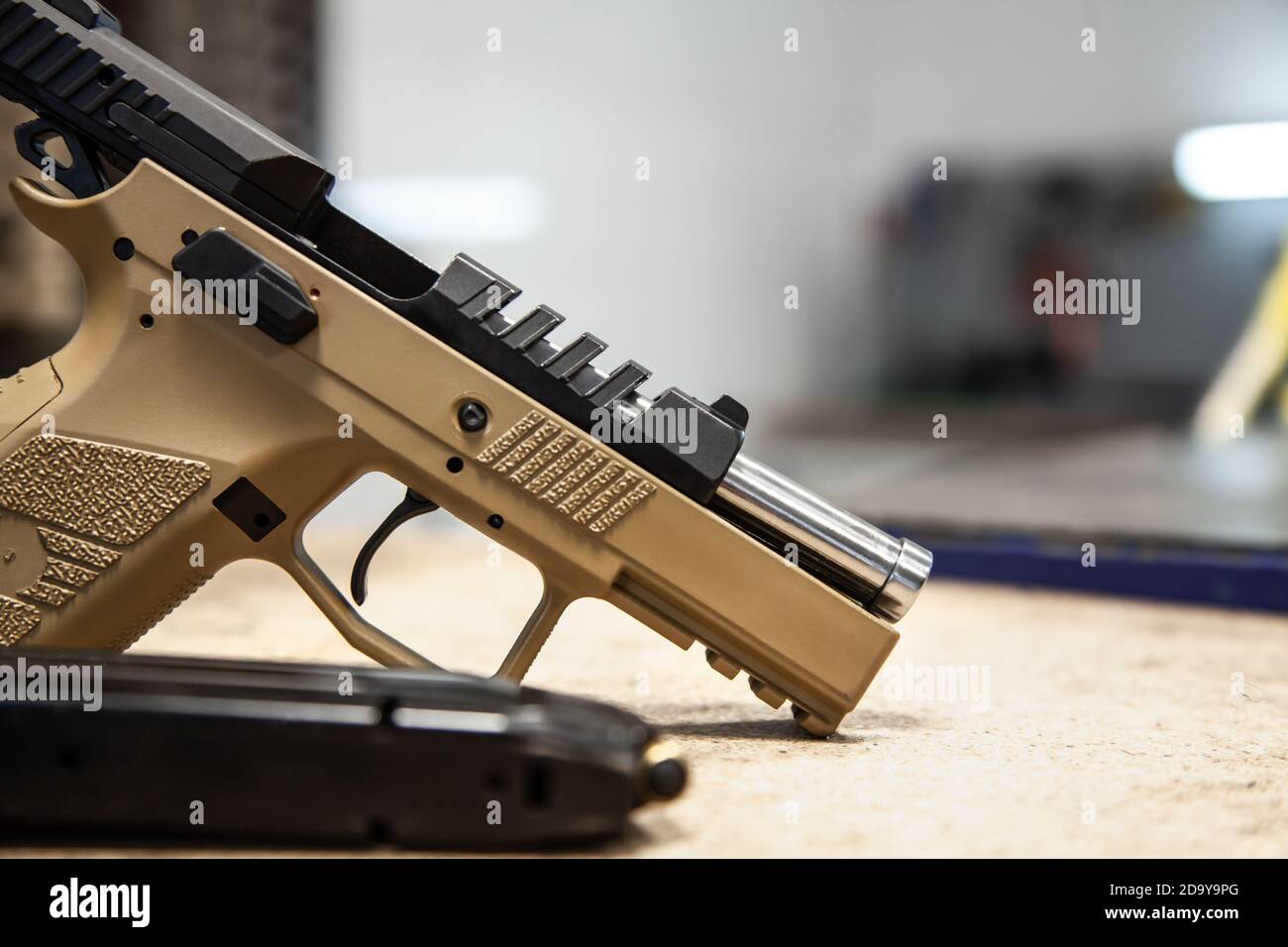 Modern black-brown traumatic pistol on the table. Unloaded weapon for ...