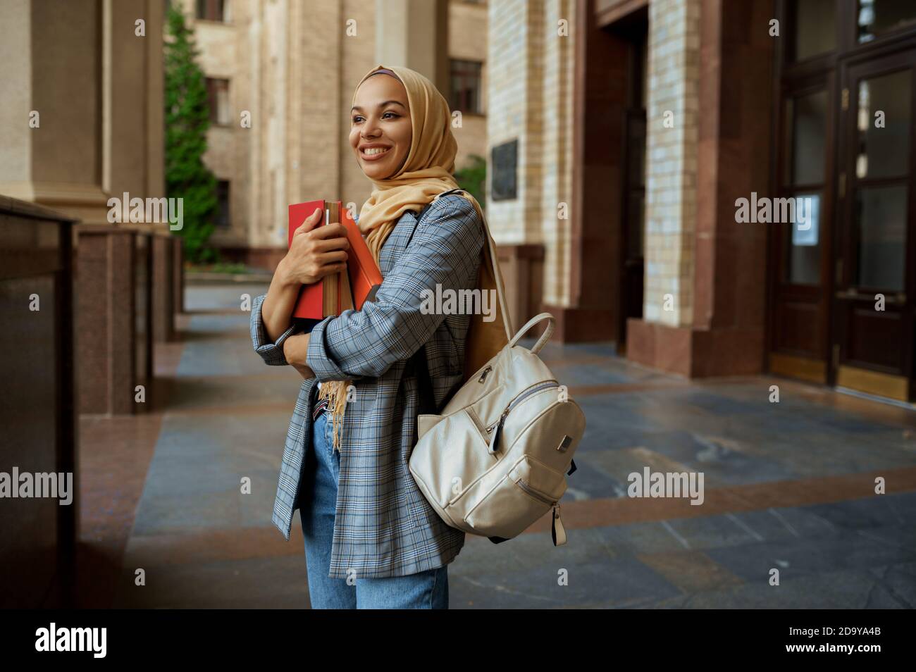 Arab student with books at university entrance Stock Photo - Alamy