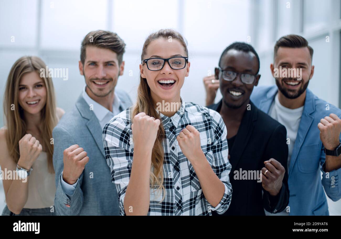 Portrait of friendly team of employees rejoicing in the office Stock ...