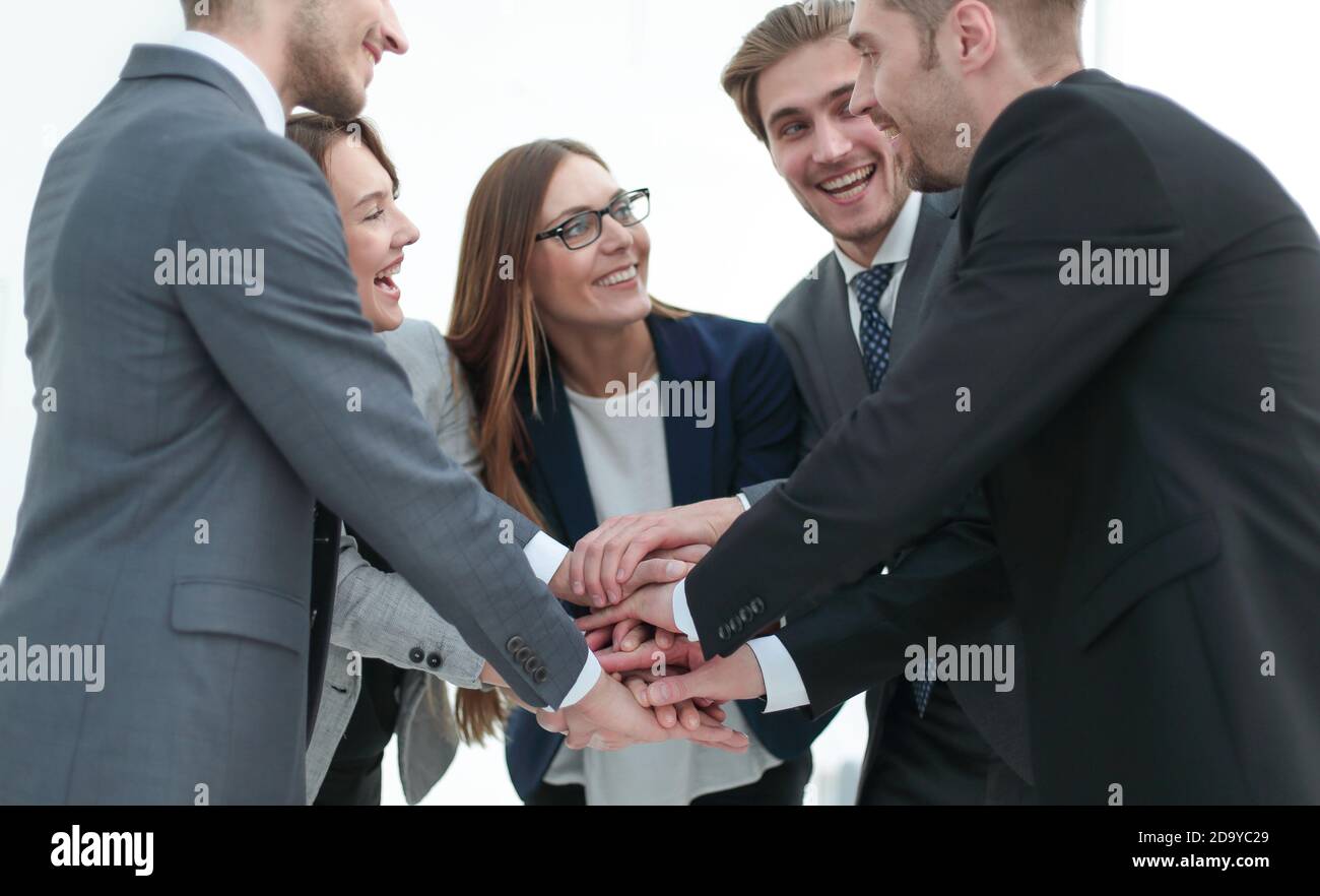 Close-up of people holding hands together while Stock Photo - Alamy