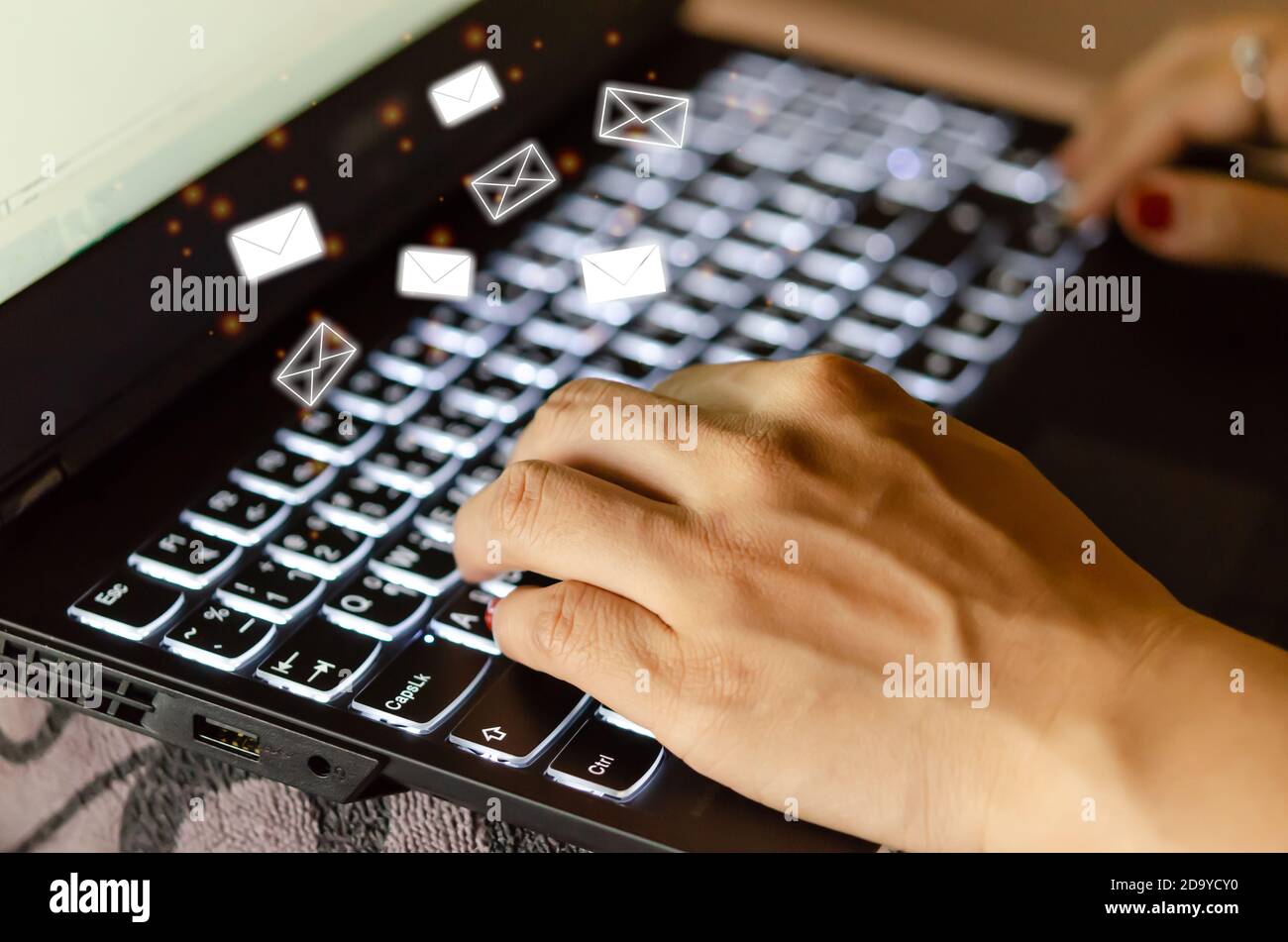 Closeup shot of female hands using keyboard computer laptop with flying ...