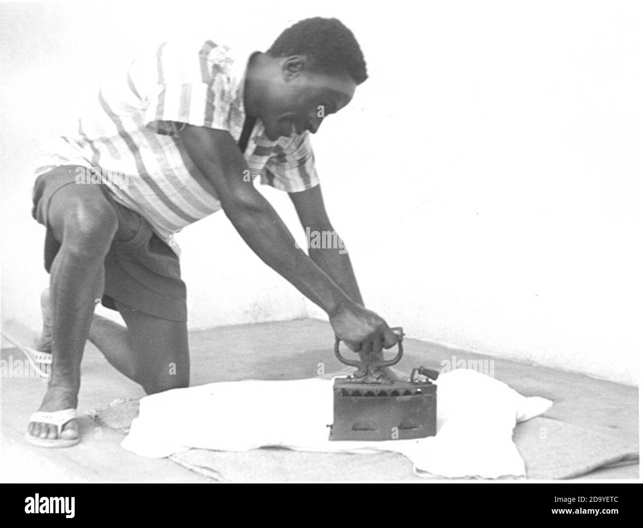 Schoolboy ironing uniform Ghana Stock Photo - Alamy