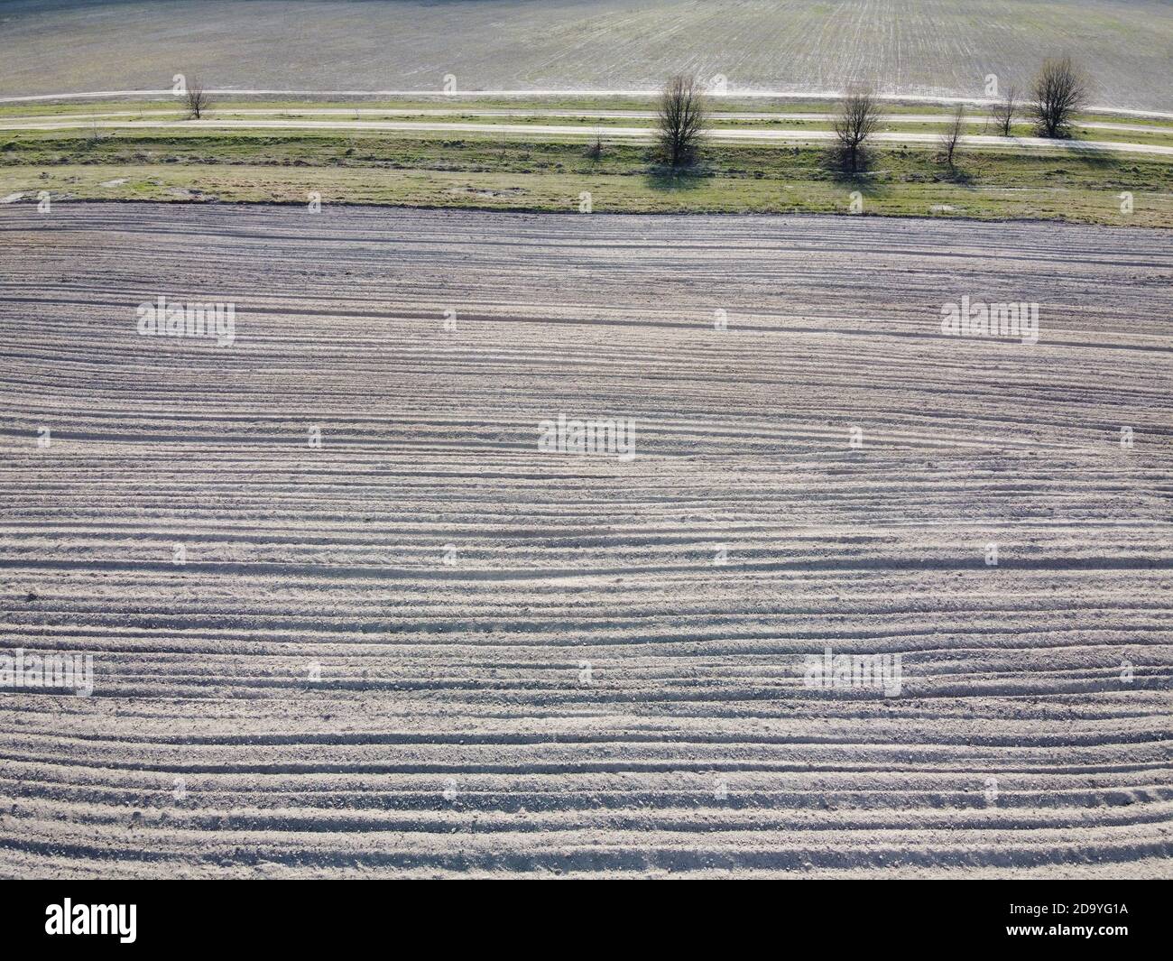 Dirt road between two plowed fields, aerial view. Agricultural land ...