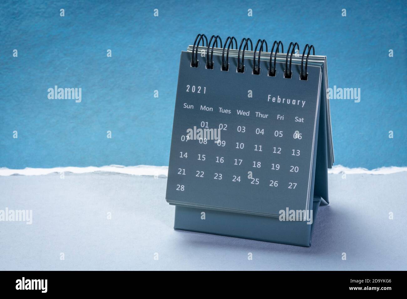 February 2021- spiral desktop calendar against colorful handmade paper ...