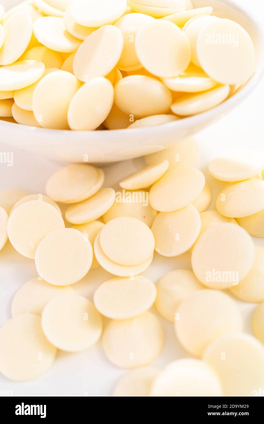 White round chocolate chips for melting chocolate shapes on a white ...