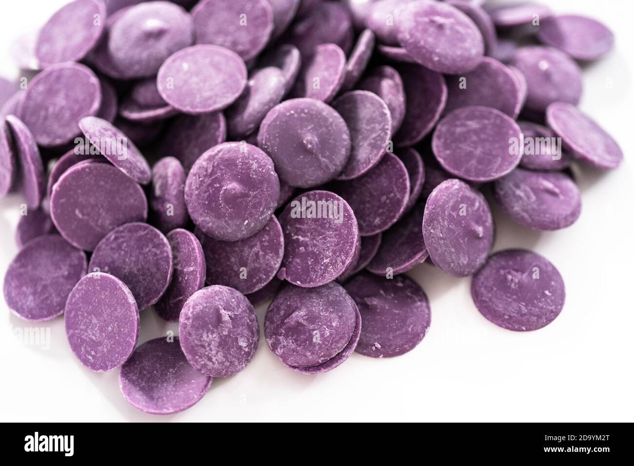 Purple round chocolate chips for melting chocolate shapes on a white ...