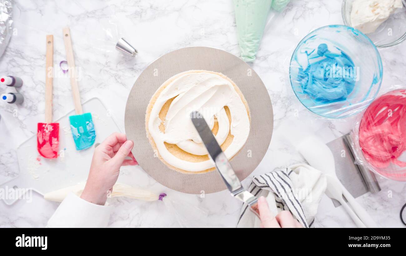 Stacking cake layers to create the round three-layer vanilla cake Stock ...