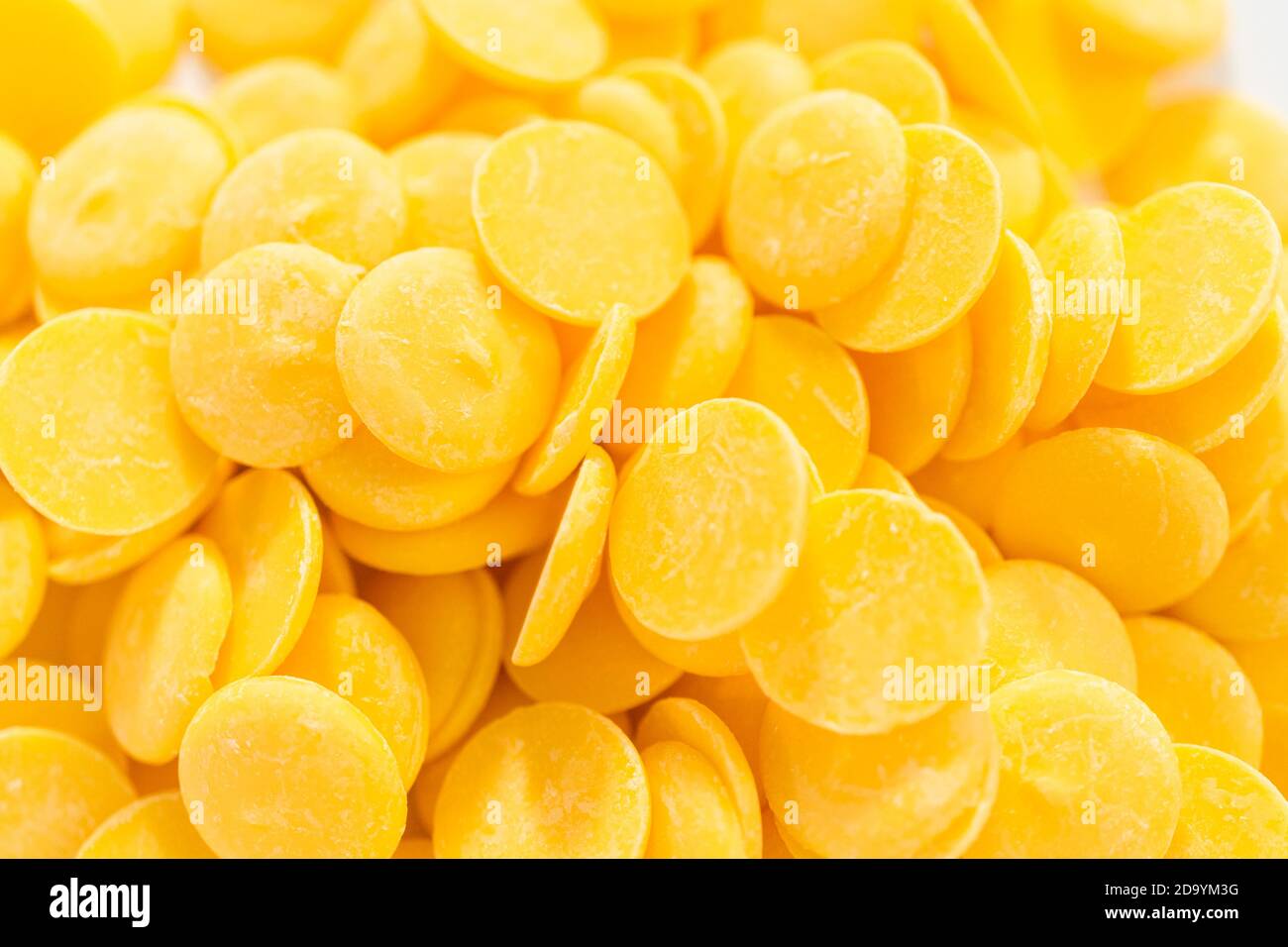 Yellow round chocolate chips for melting chocolate shapes Stock Photo ...