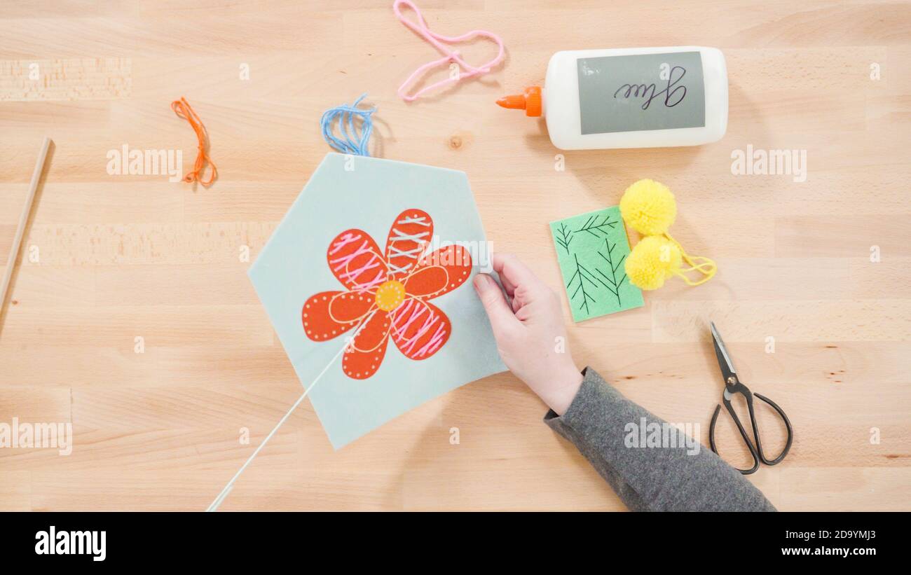 Mother teaching kids how to sew with simple sewing kit at the craft ...