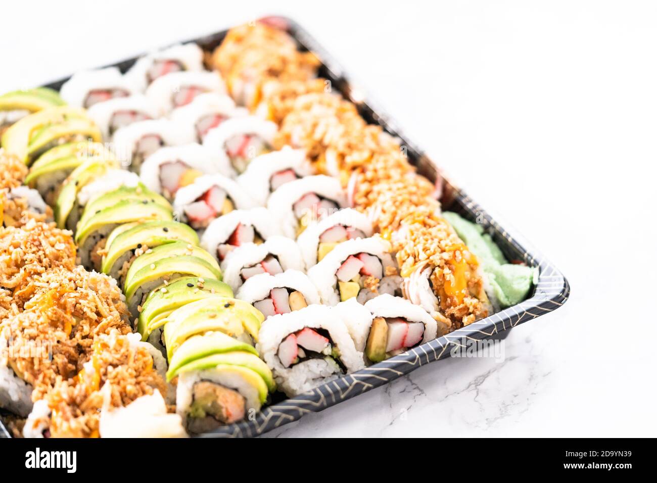 Pre-packaged variety of sushi and sushi rolls in a plastic tray Stock ...