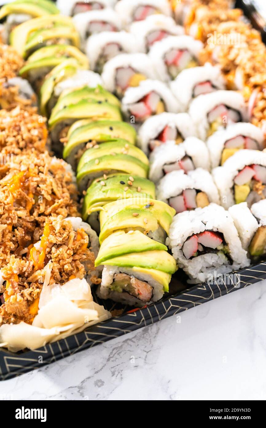 Pre-packaged variety of sushi and sushi rolls in a plastic tray Stock ...
