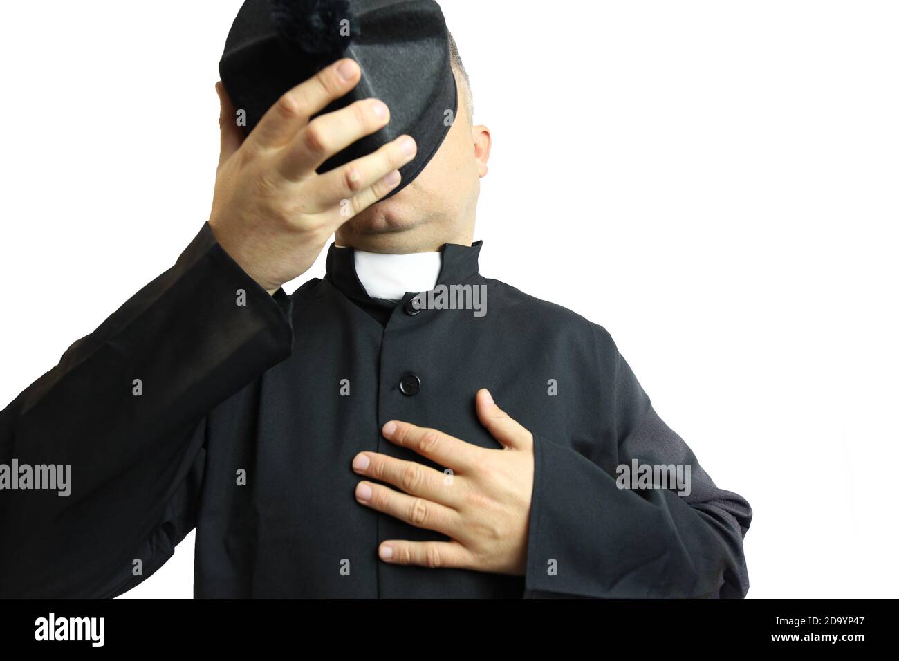 priest covering his face on a white background Stock Photo - Alamy