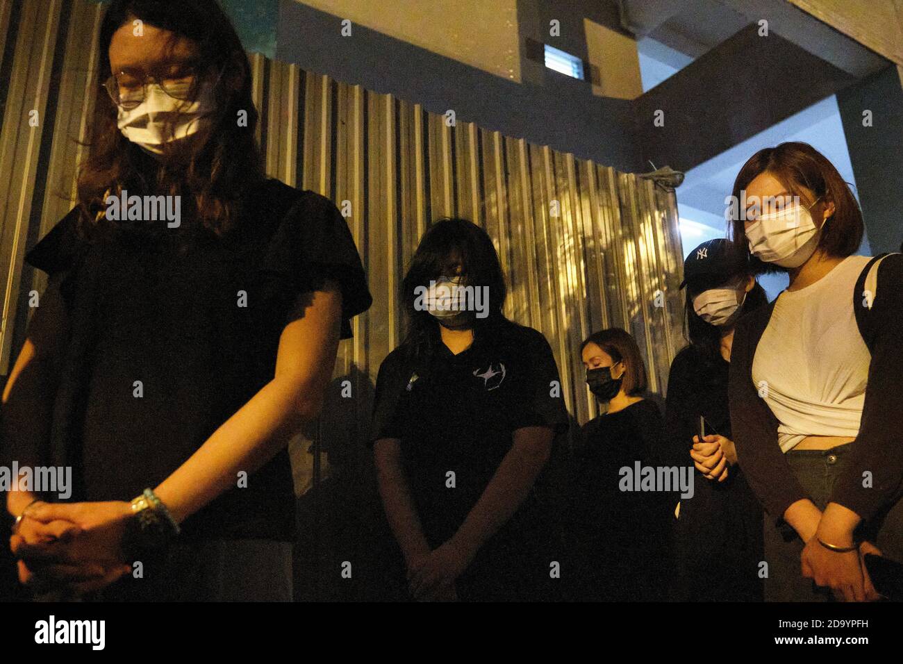 Mourners wearing face masks pay tribute to Alex Chow Tsz-lok.Mourners ...